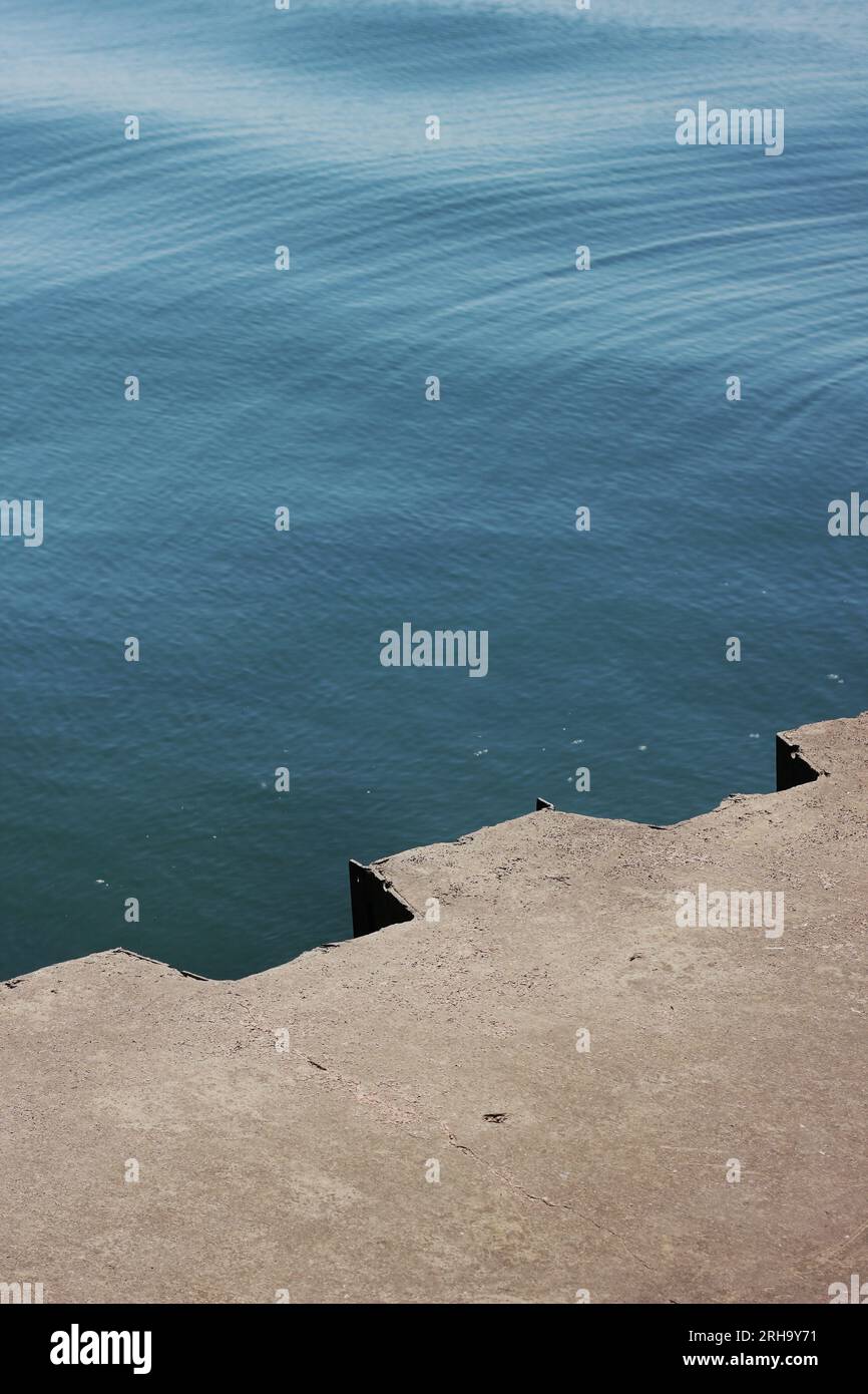 Minimalist view of a corrugated steel retaining wall creating a pier ...
