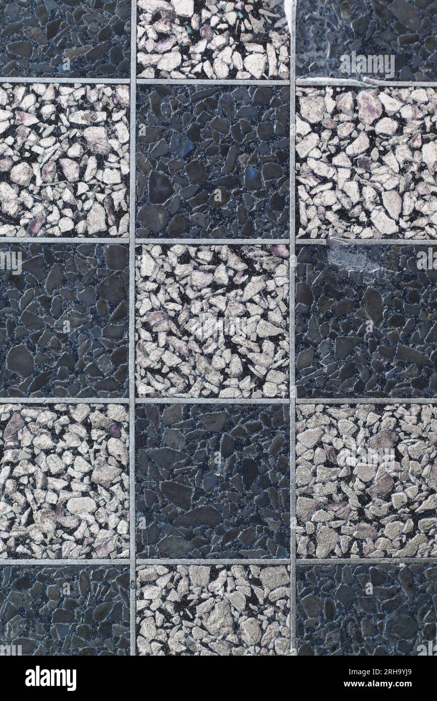 Repeating patternof square tiles with perpendicular lines and gravel ...