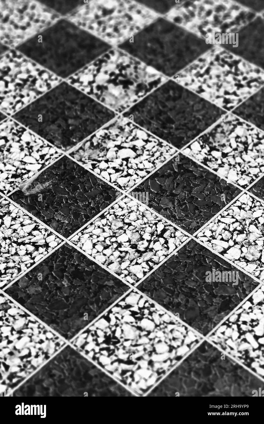 Repeating patternof square tiles with perpendicular lines and gravel ...