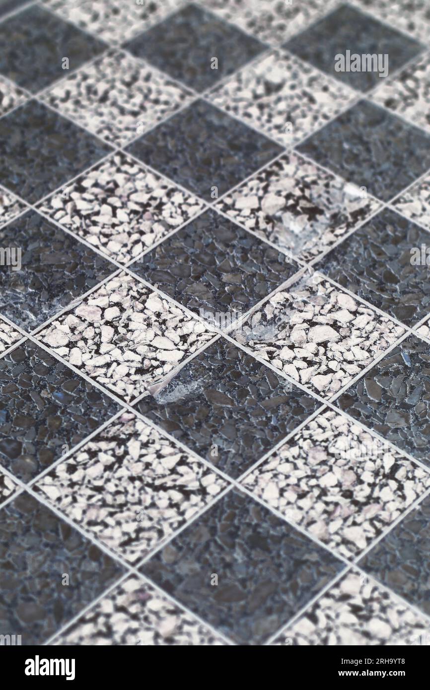 Repeating patternof square tiles with perpendicular lines and gravel ...