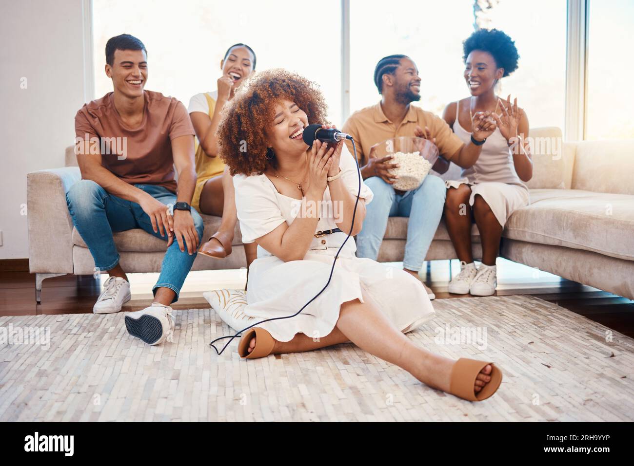 Mic, happy people or woman singer in home living room together in a ...