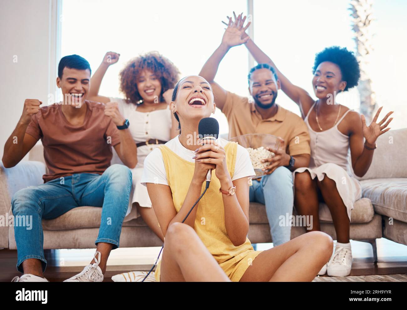 Female friends singing karaoke house hi-res stock photography and ...