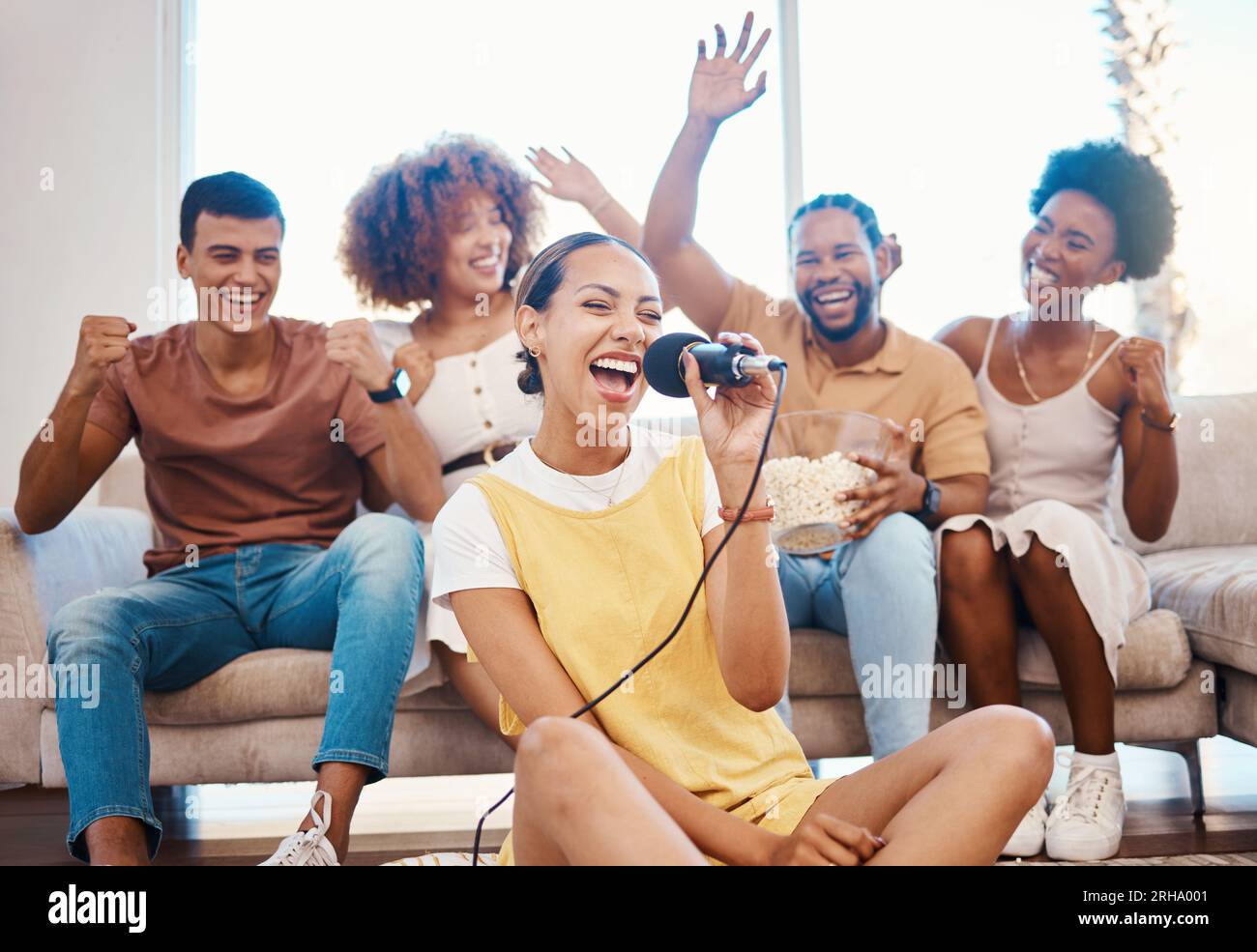 Female friends singing karaoke house hi-res stock photography and ...