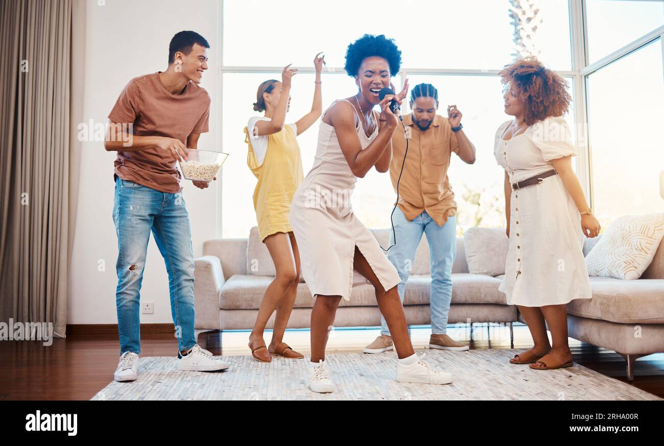 Singing, music and friends doing karaoke in the living room with ...