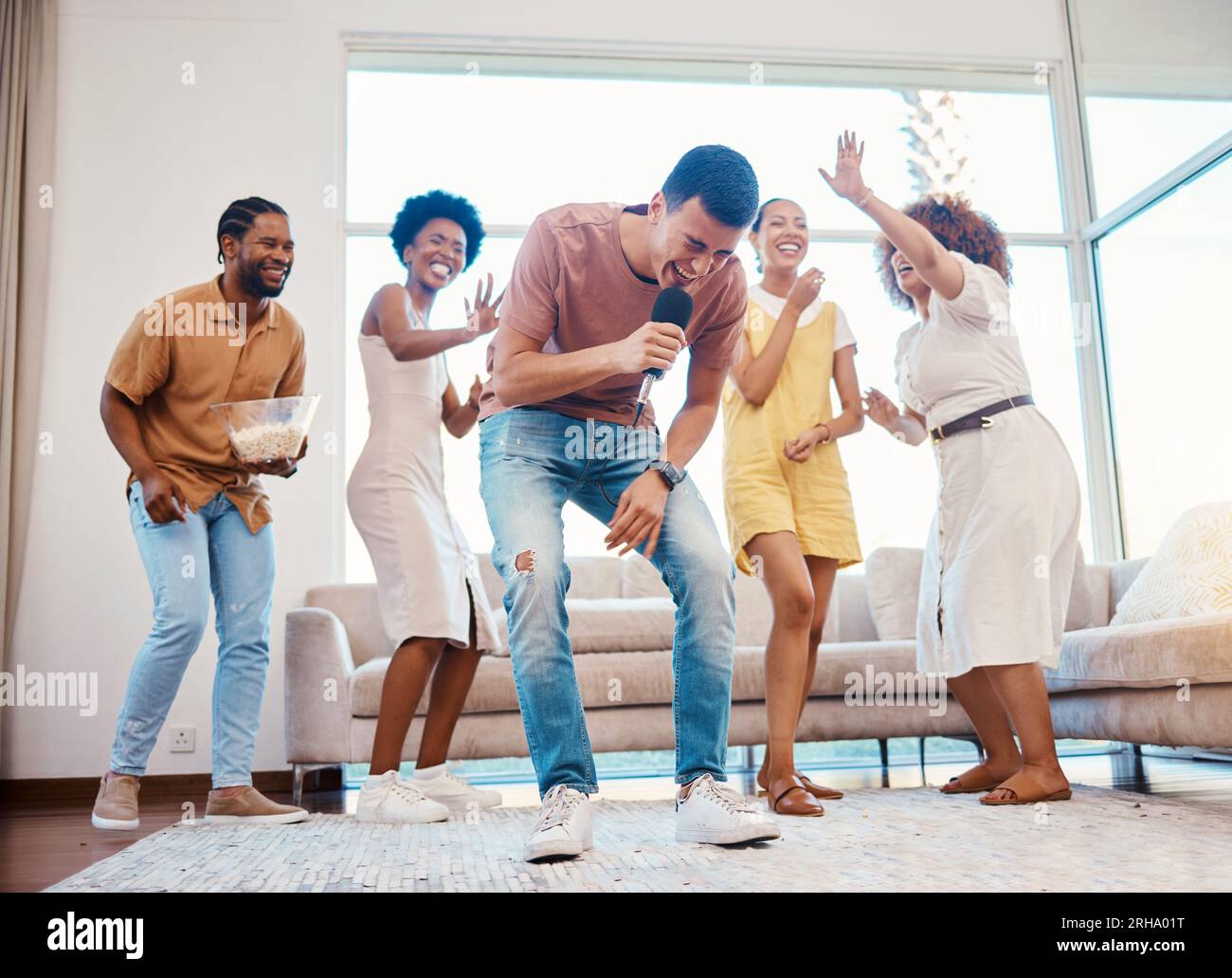 Singing, party and friends dancing in the living room with a microphone ...