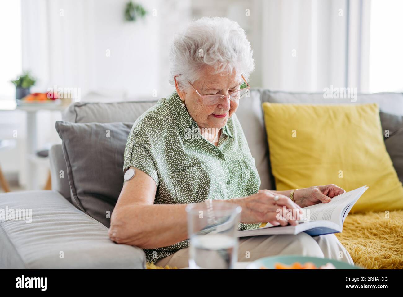 Diabetic senior patient using continuous glucose monitor to check blood ...