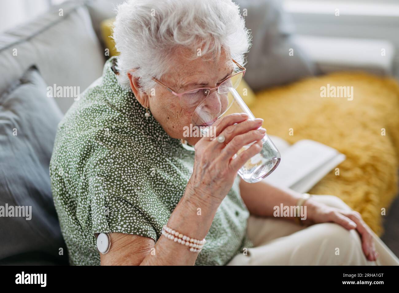 Diabetic senior patient using continuous glucose monitor to check blood ...