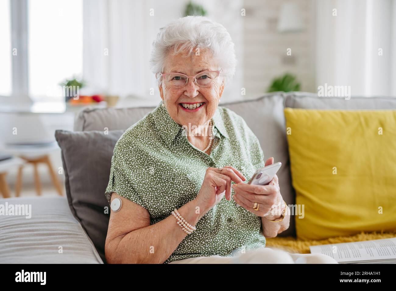 Diabetic senior patient using continuous glucose monitor to check blood ...