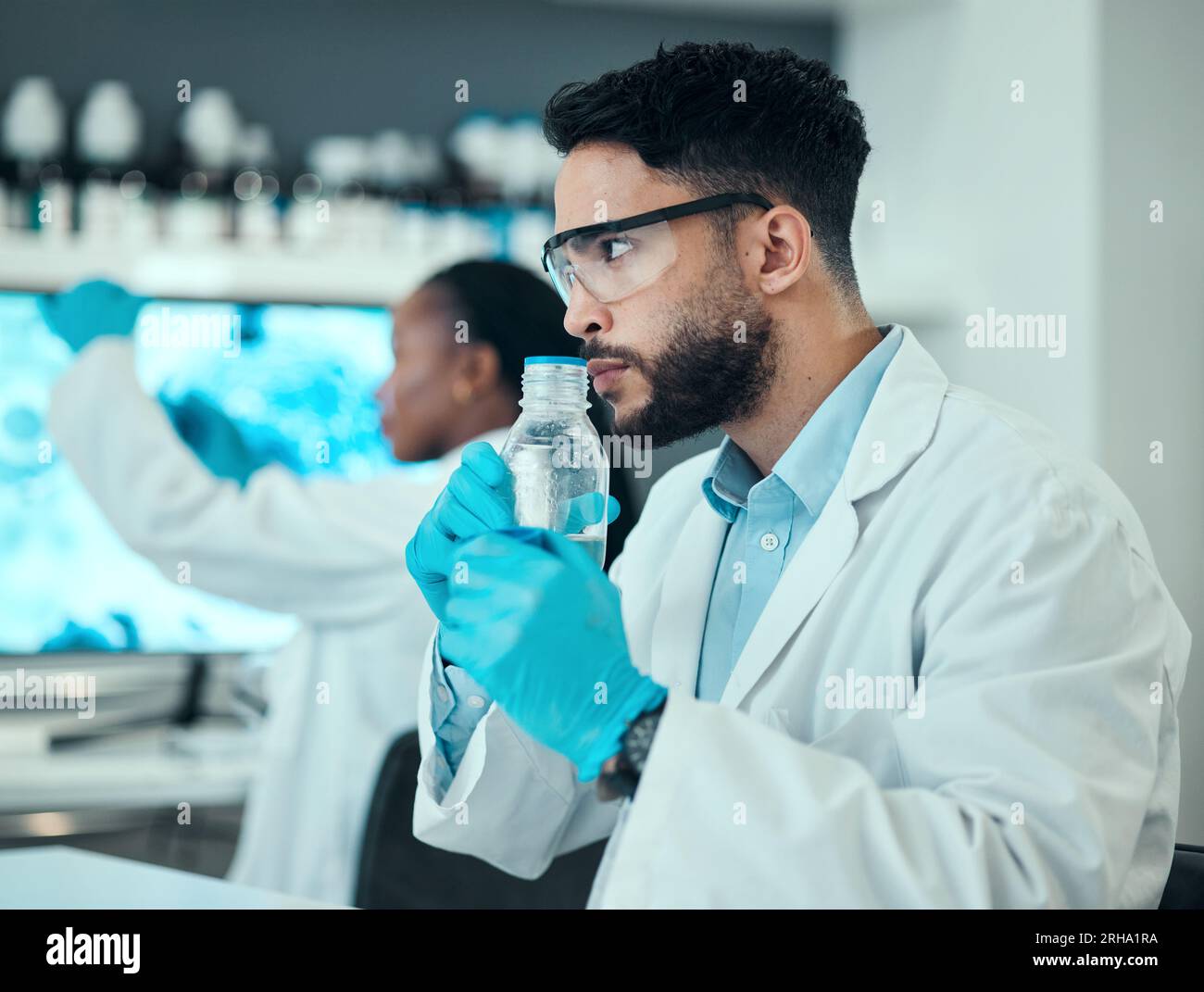 Science, smell and chemical with man in laboratory for liquid analysis ...
