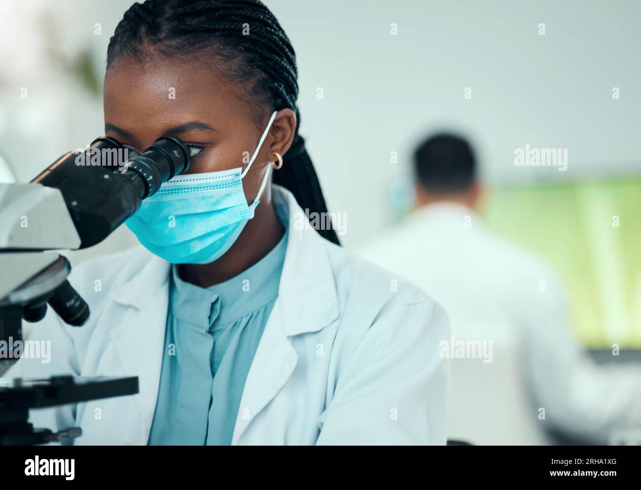 Scientist and microscope and facemask hi-res stock photography and ...