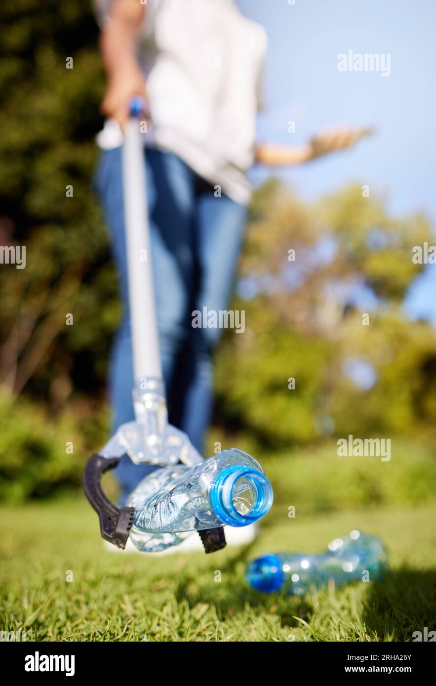 Park, pollution and closeup for cleaning, plastic bottle and and tools ...