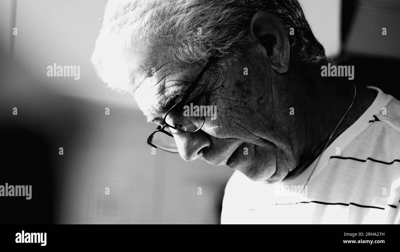Mature man in emotional turmoil, eyes shut and in despair, monochrome ...