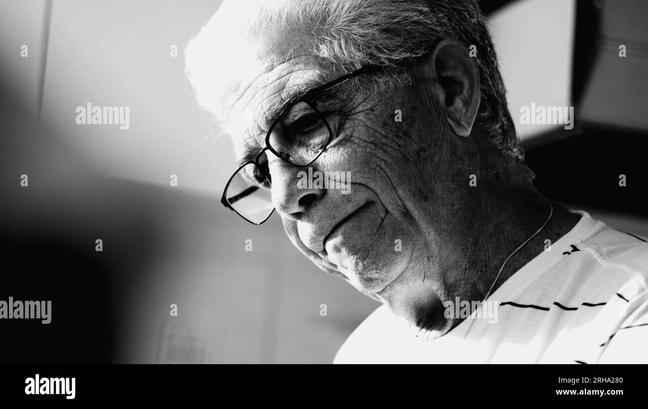Mature man in emotional turmoil, eyes shut and in despair, monochrome ...