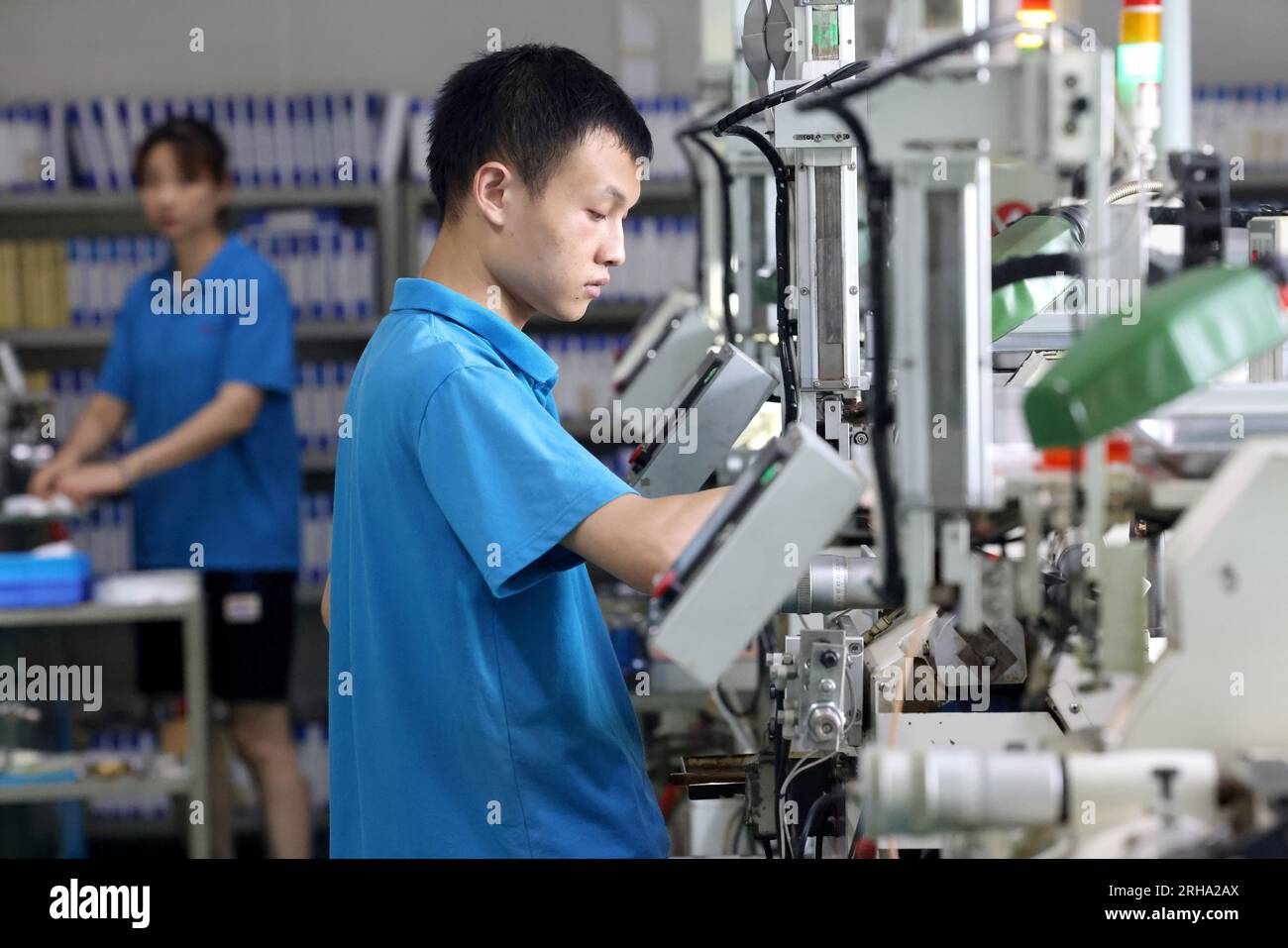 FUZHOU, CHINA - AUGUST 15, 2023 - A worker produces industrial machine ...