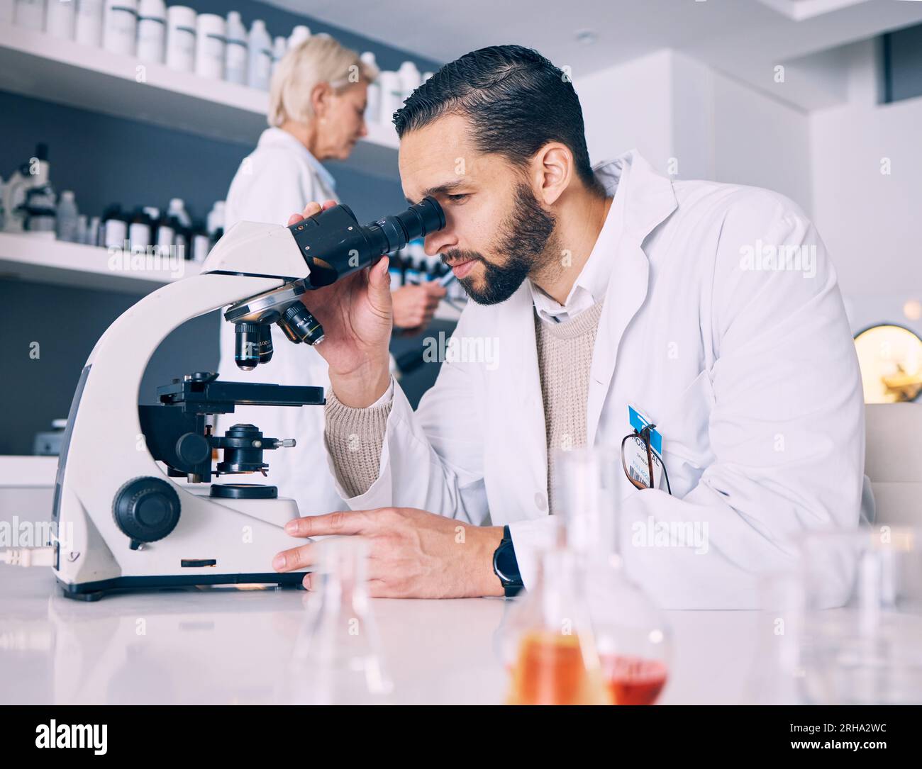 Science man, microscope analysis and laboratory for research, molecules or particles of bacteria ...