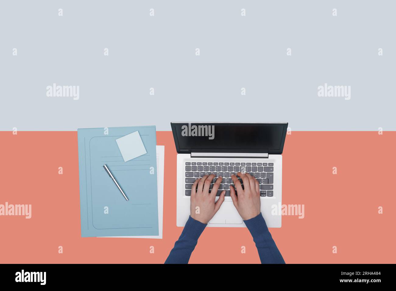 Business person sitting at desk and working with a laptop, top view ...