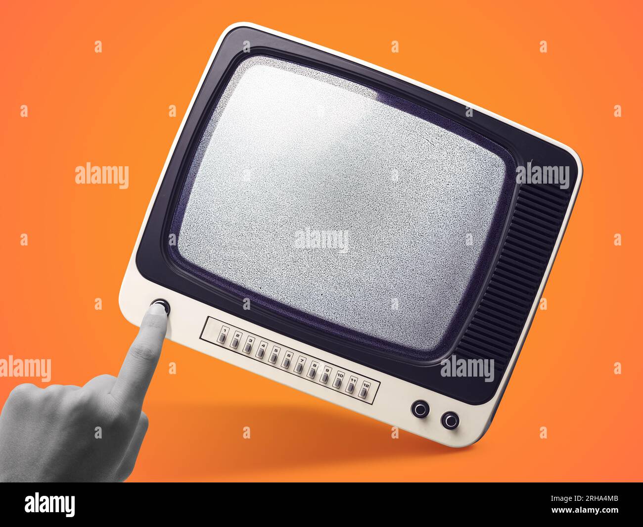 Woman touching a knob on a vintage TV: media and entertainment concept ...