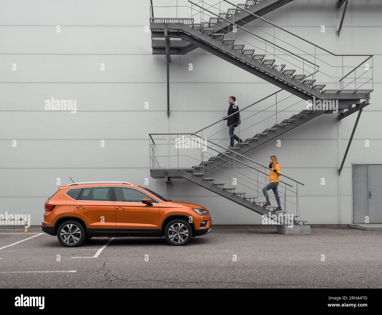 samoa orange SEAT Ateca crossover in front of grey wall. Side profile ...