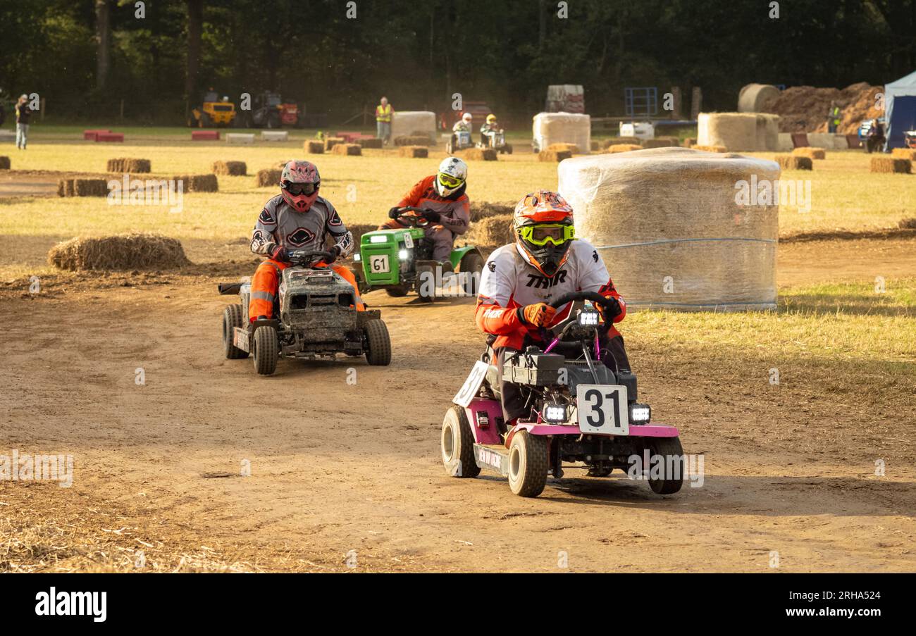 Racing lawn mower drivers race around a corner at sunrise in the BLMRA ...