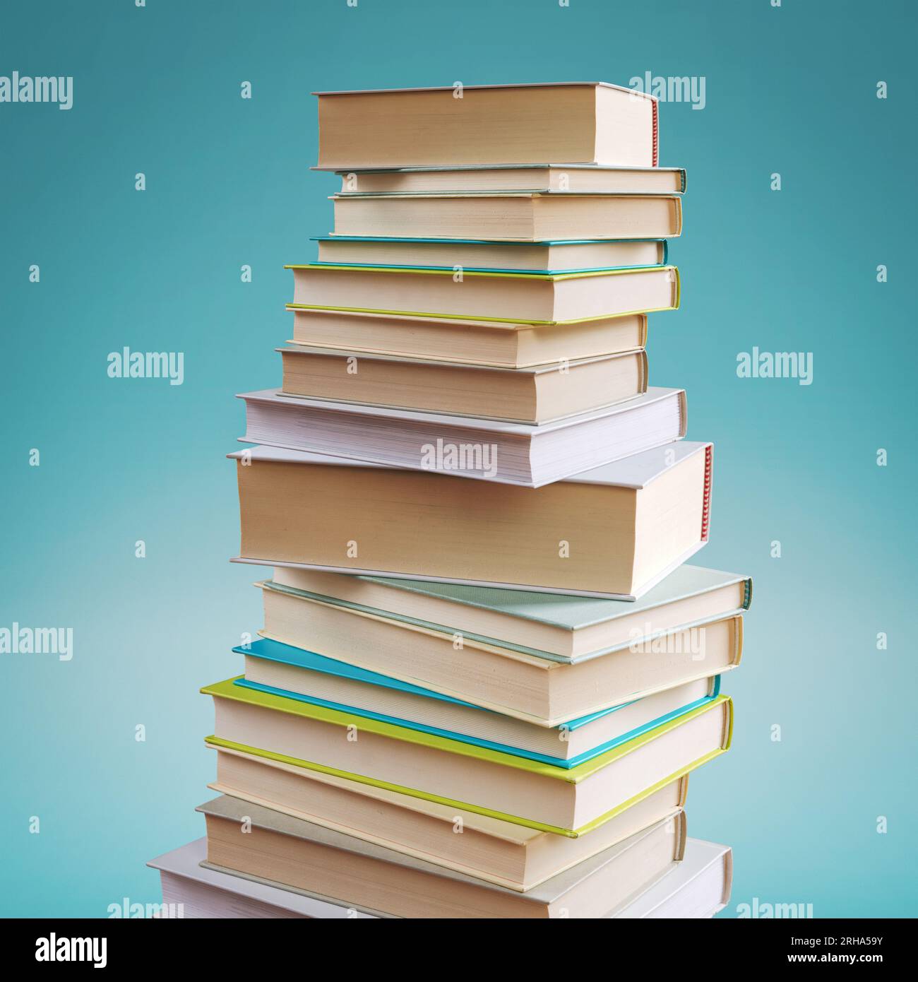 Many stacked books on blue background, learning and reading concept ...