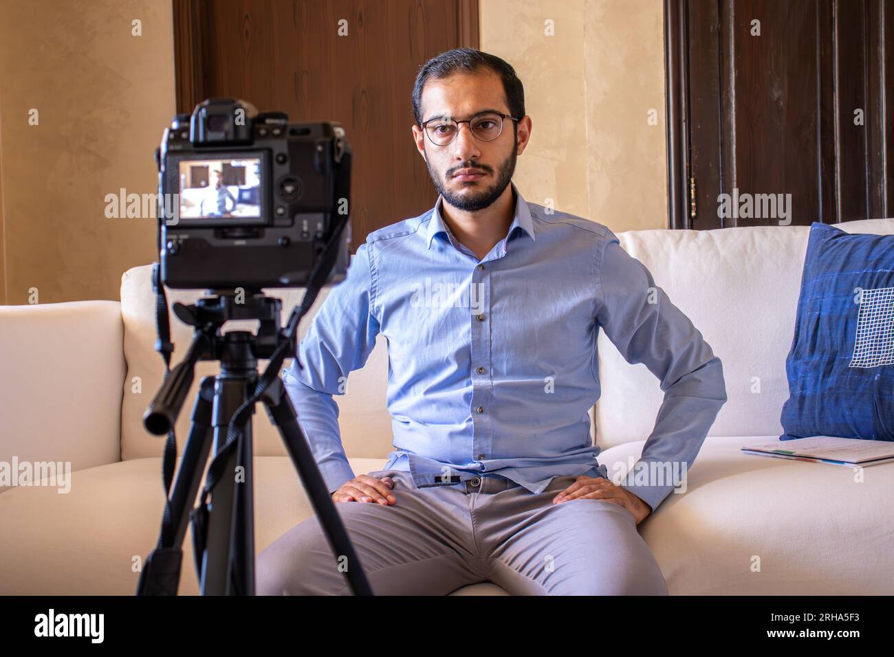 Young arabic man conducting a seminar from home Stock Photo - Alamy