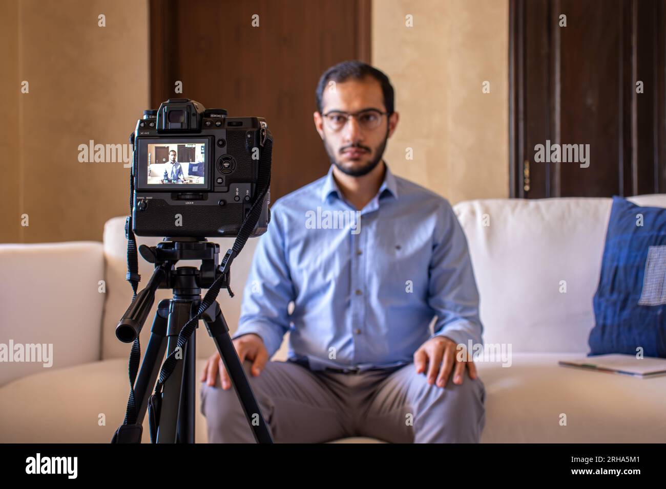Young arabic man conducting a seminar from home Stock Photo - Alamy