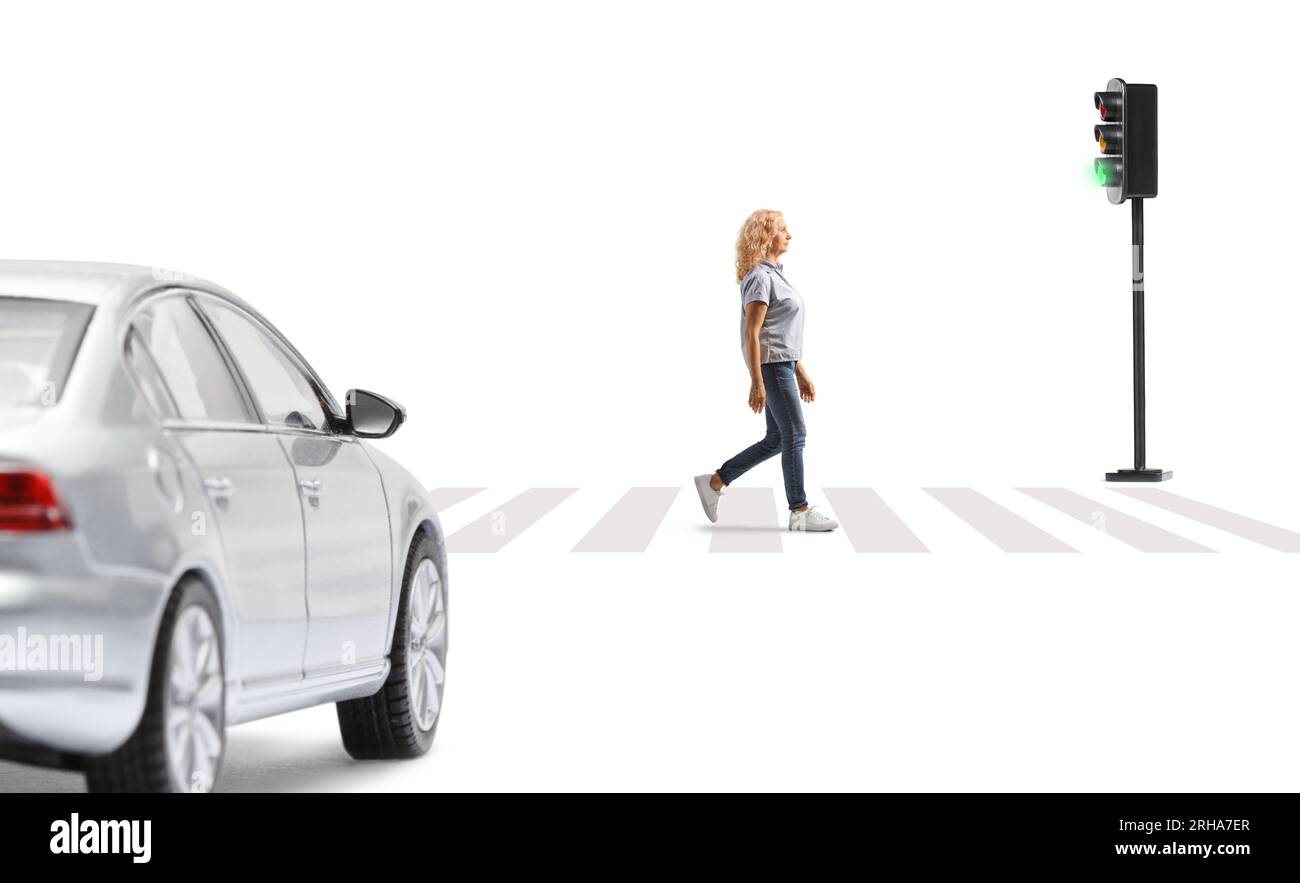 Woman walking on a street at a pedestrian crosswalk and car driving ...