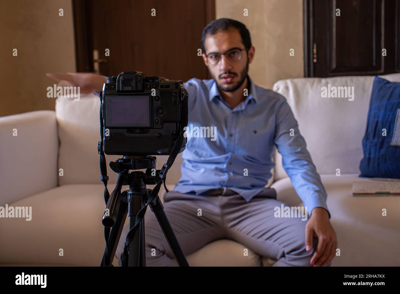 Young arabic man conducting a seminar from home Stock Photo - Alamy