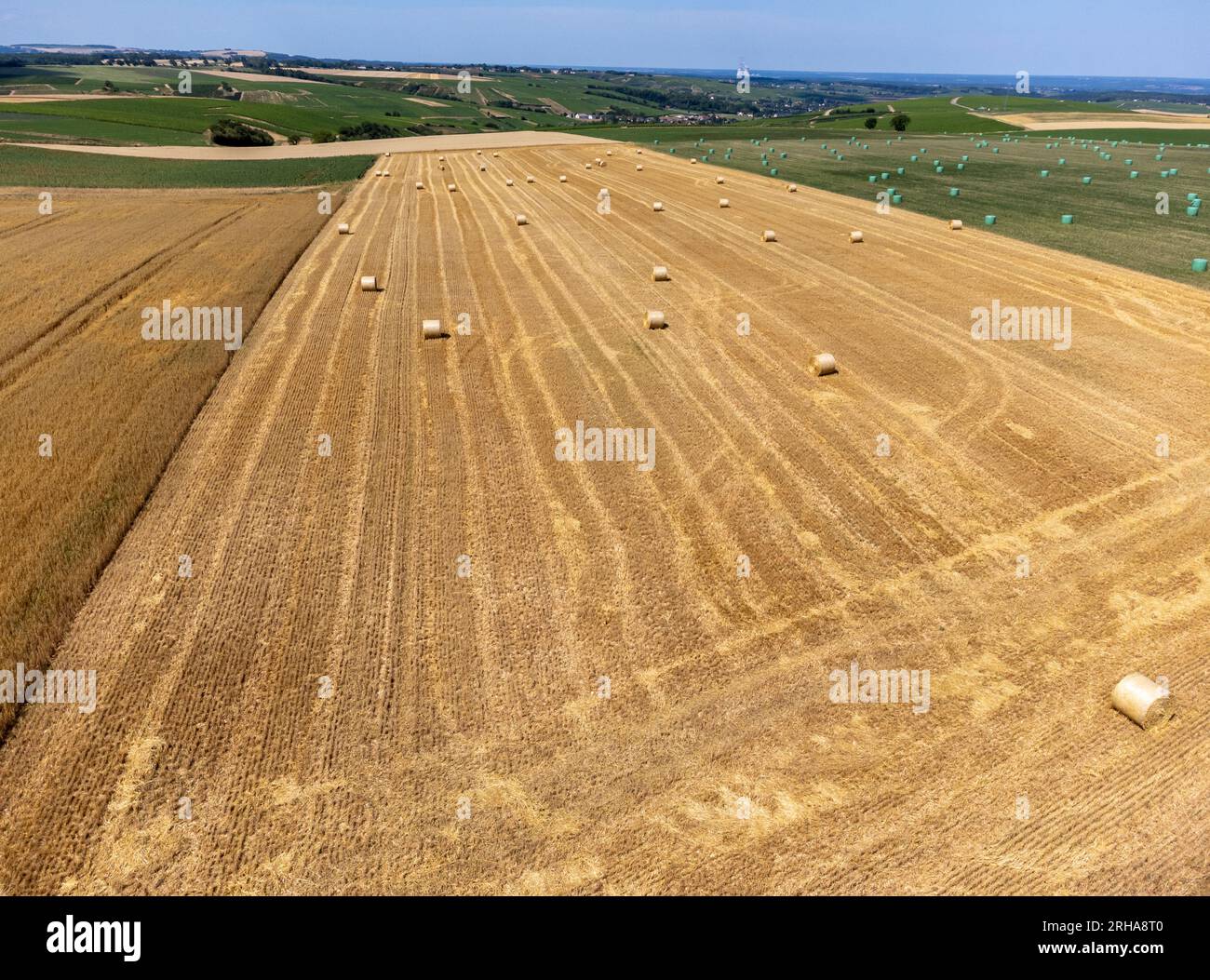 Aerial view, agriculture in France, yellow haystacks on golden wheat ...