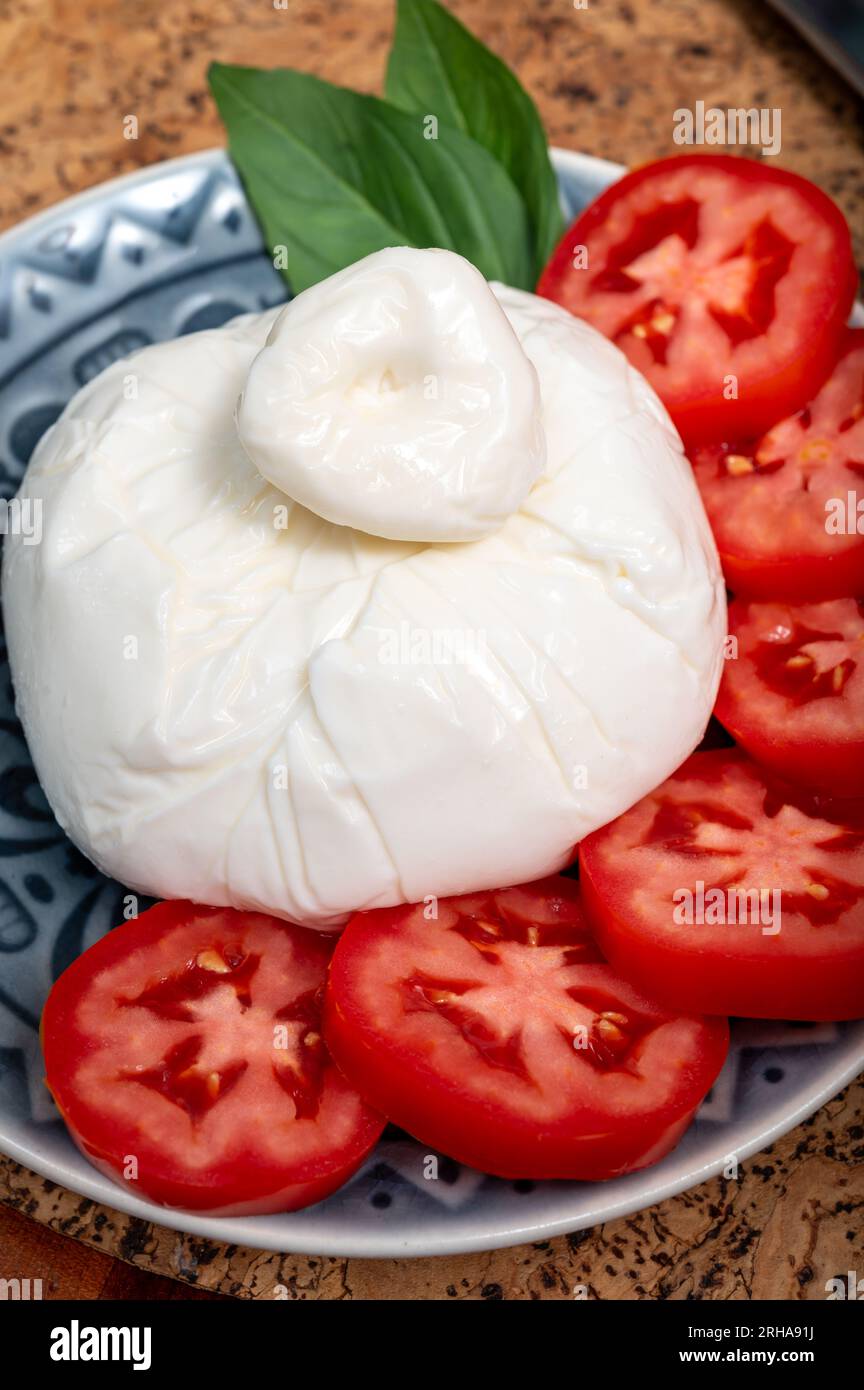 Fresh handmade soft Italian cheese from Puglia, white ball of burrata ...