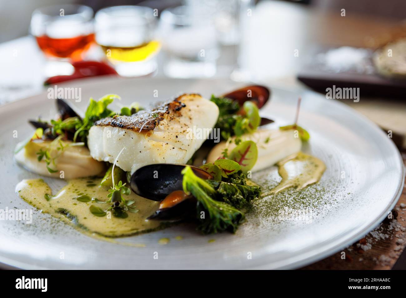 Cod fillet with cauliflower cream, asparagus, clam-wine sauce and ...