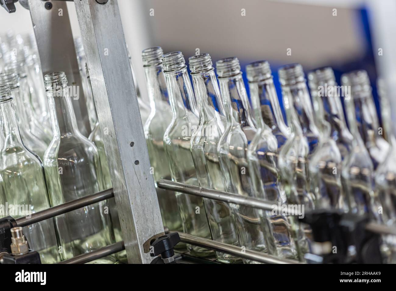 Glassworks. Glass industry. A lot of glass bottles on the conveyor in a ...