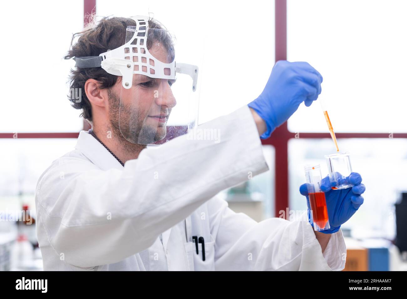 Young scientist in a research laboratory creating a scientific experiment, laboratory concept ...