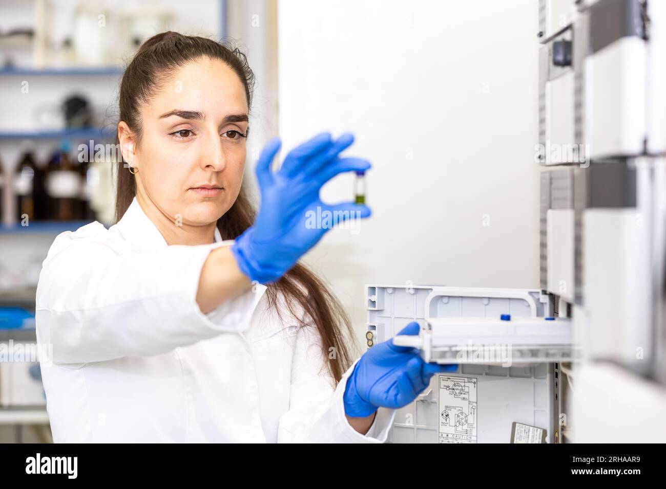 Young woman scientist in a research laboratory creating a scientific experiment, laboratory ...