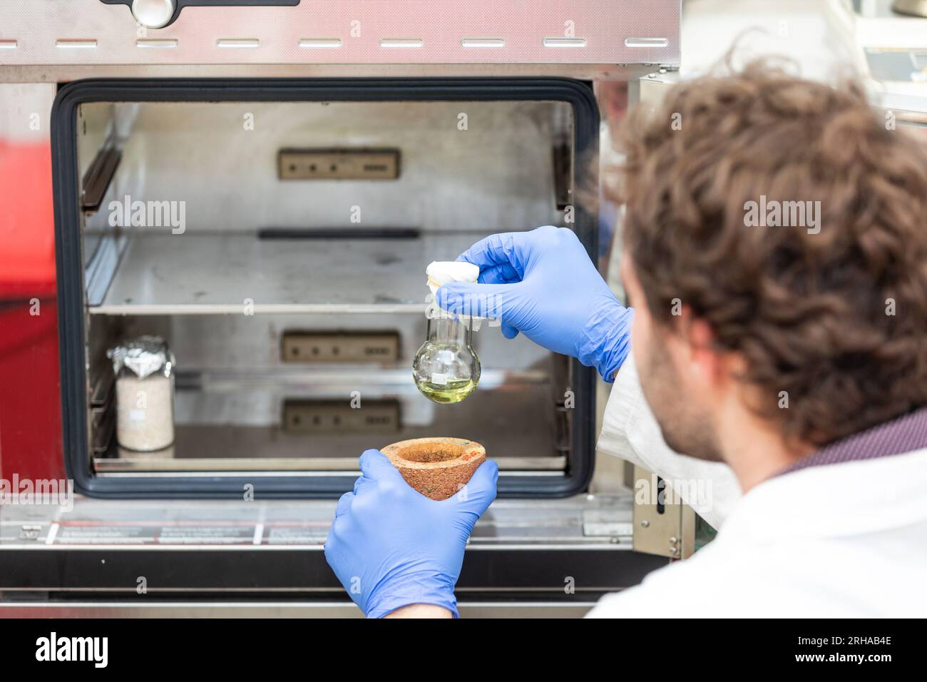 Young scientist in a research laboratory creating a scientific ...