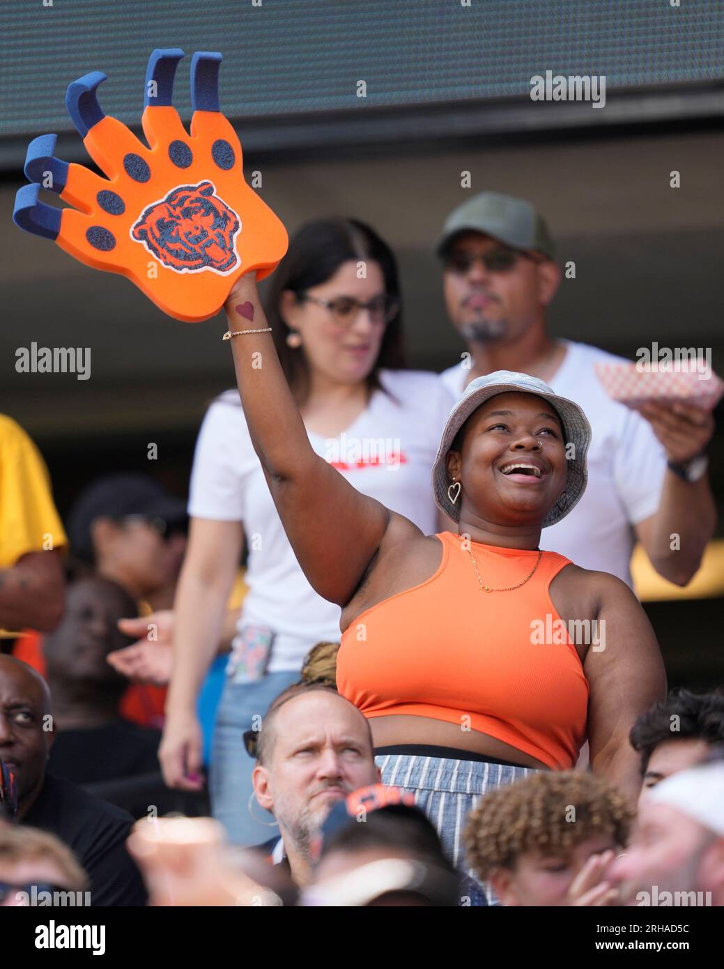 A Chicago Bears fans smiles as she sees herself on the video board ...