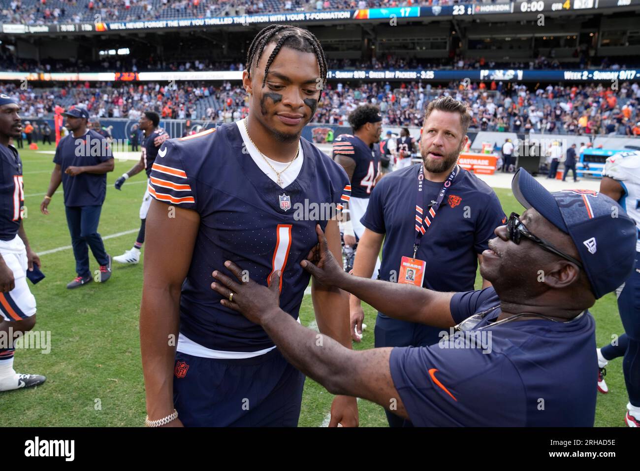 Chicago Bears quarterback Justin Fields, left, talks with the team's ...