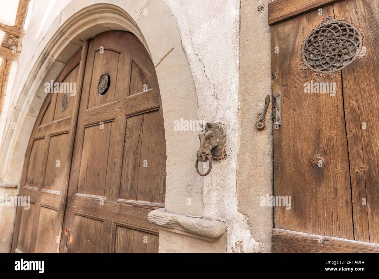 Old rusty horse's head with a ring for tying horses in a backyard ...