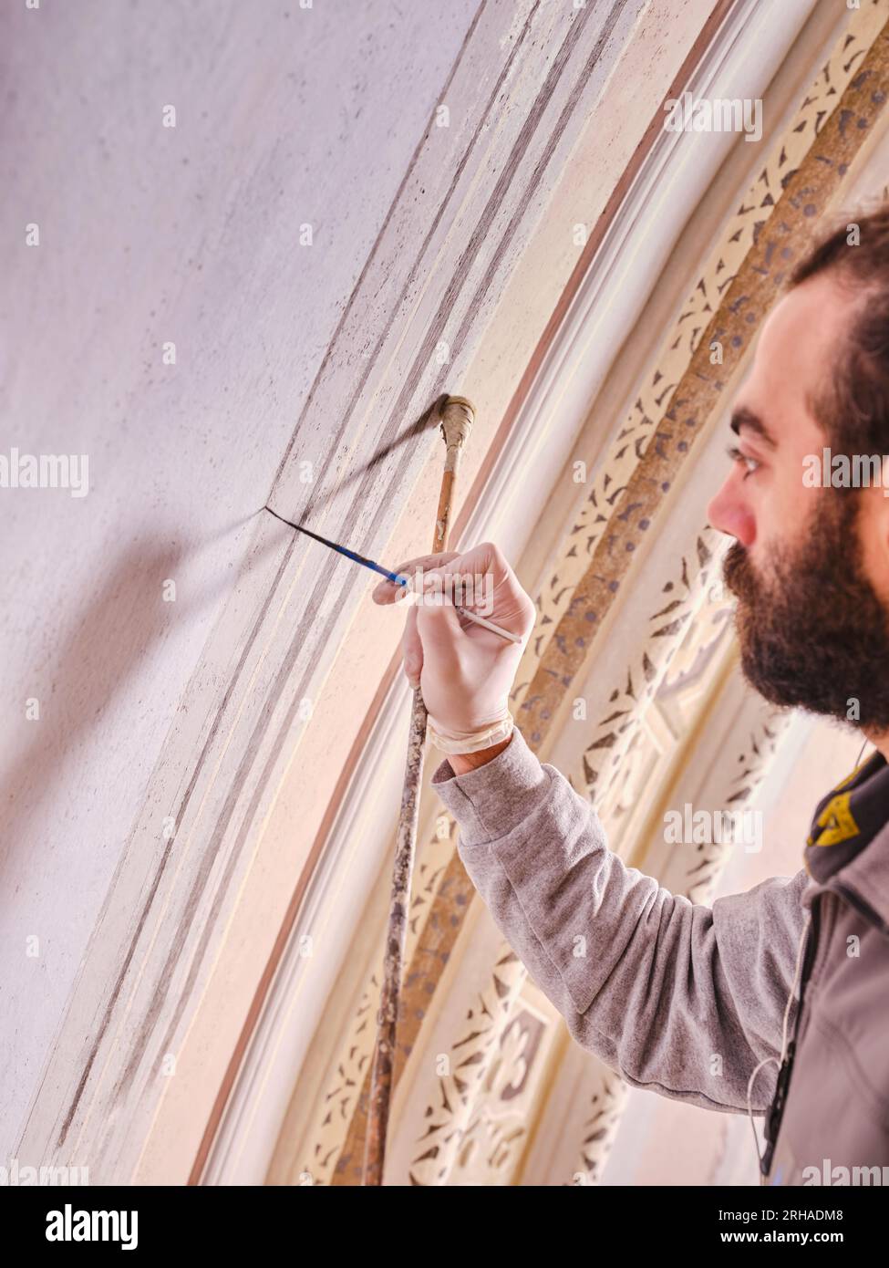 female artist doing old painting restoration. wall painting historical ...