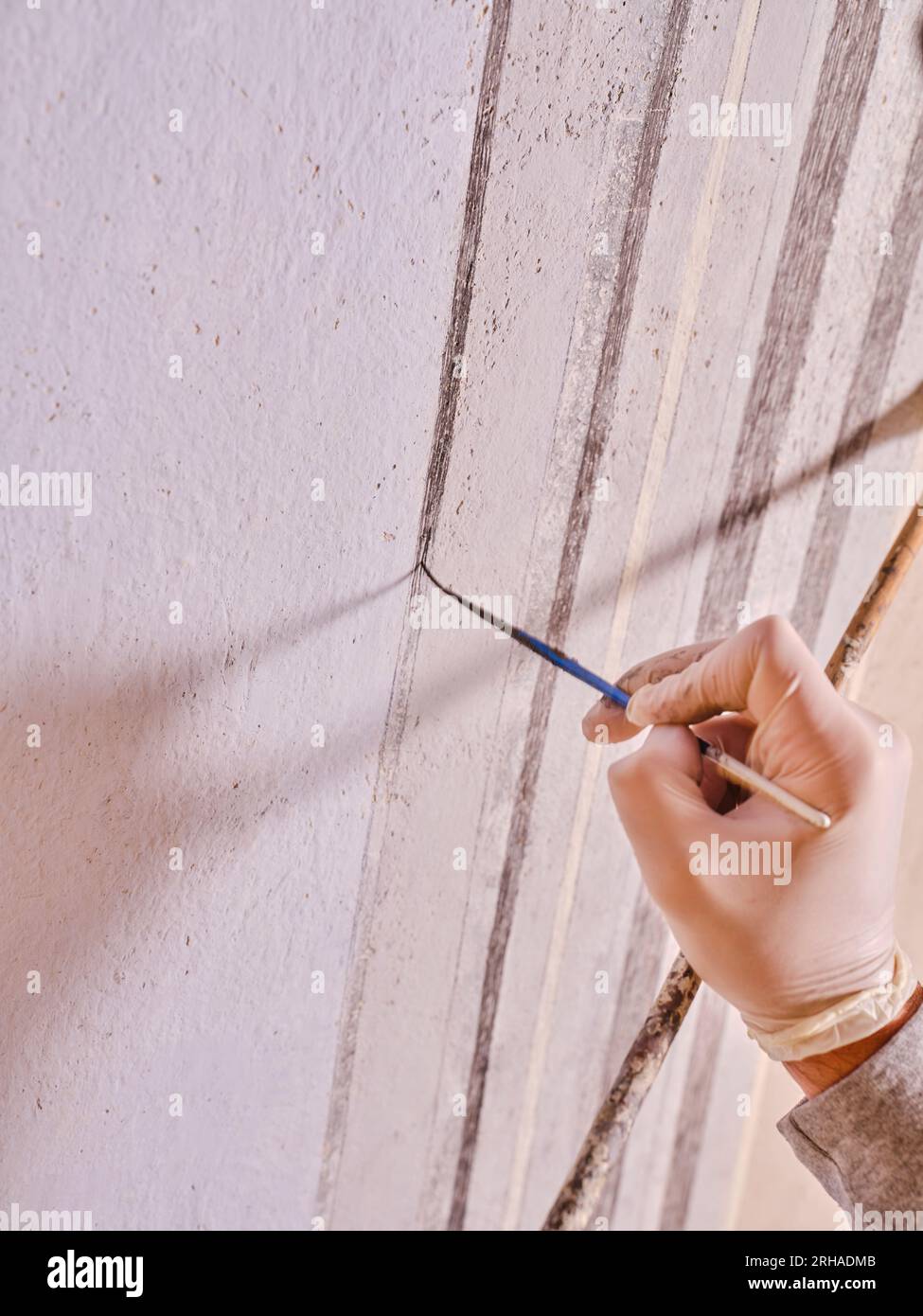 female artist doing old painting restoration. wall painting historical ...