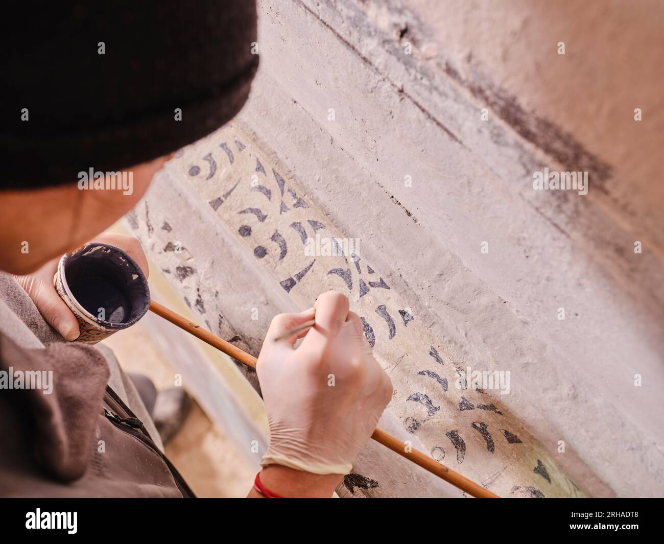 female artist doing old painting restoration. wall painting historical ...