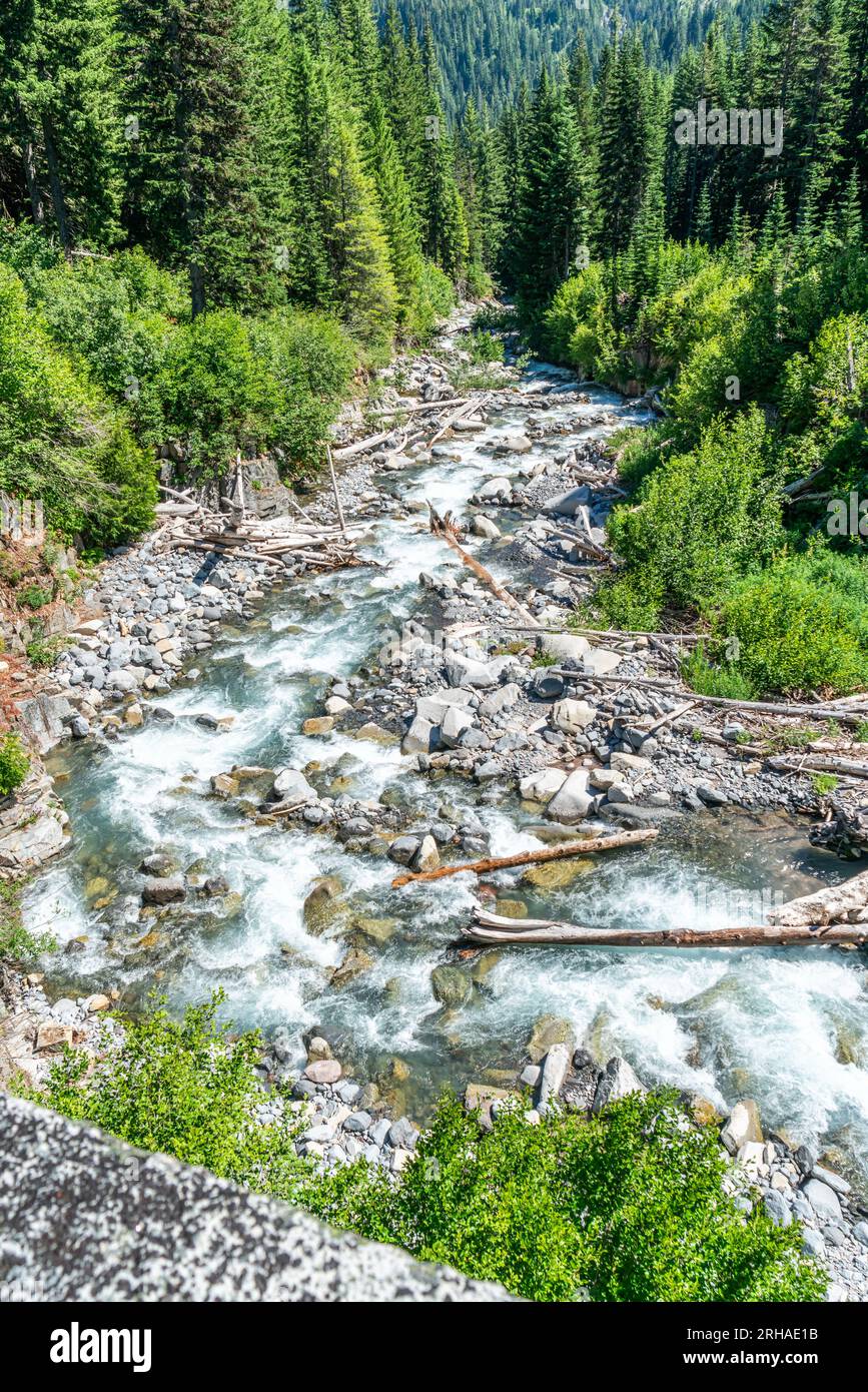 A river from a glacier flows under a highway in Mount Rainier National ...