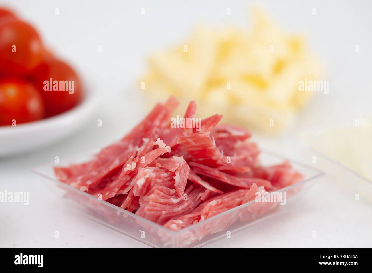 Salami pizza topping ingredients. Pizza preparation Stock Photo - Alamy