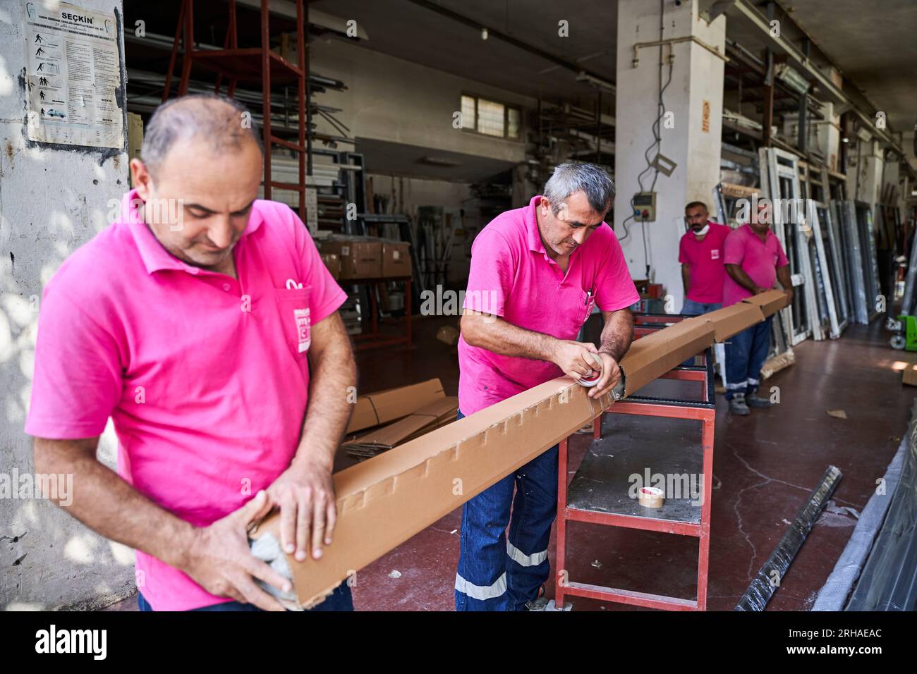 Workers packing cardboard box in warehouse for shipment. an operator ...