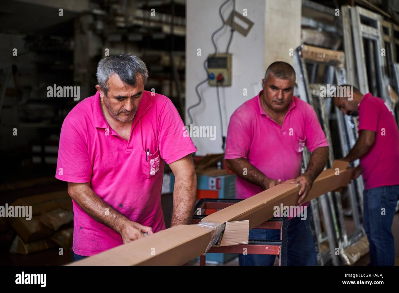 Workers packing cardboard box in warehouse for shipment. an operator ...