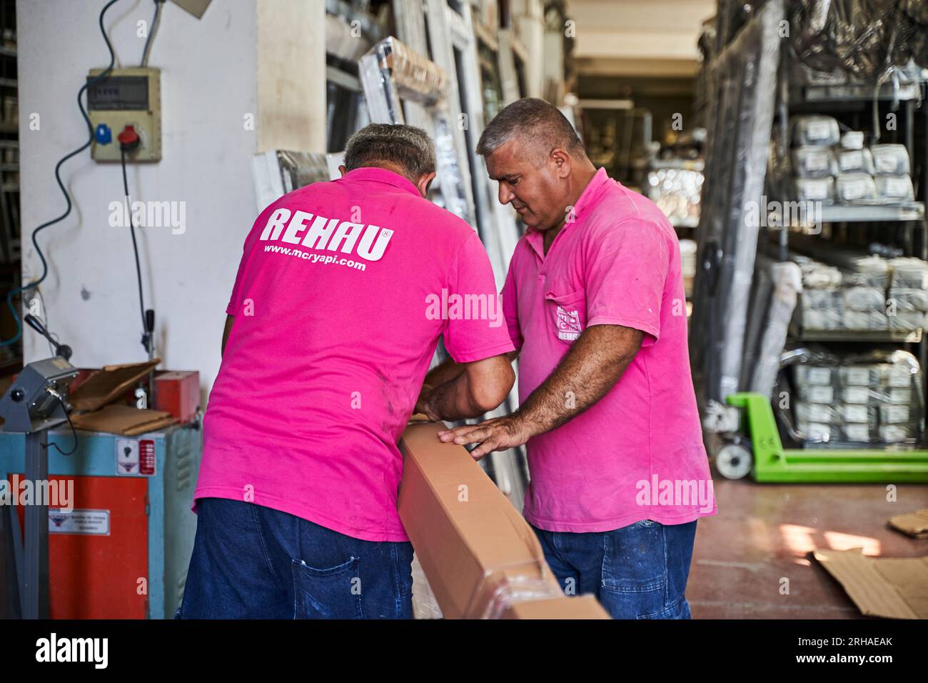 Workers packing cardboard box in warehouse for shipment. an operator ...