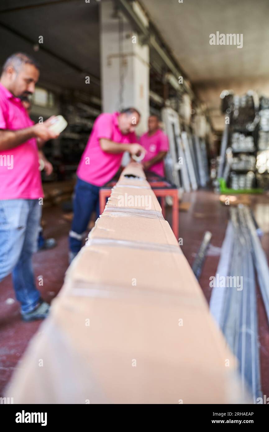 Workers packing cardboard box in warehouse for shipment. an operator ...