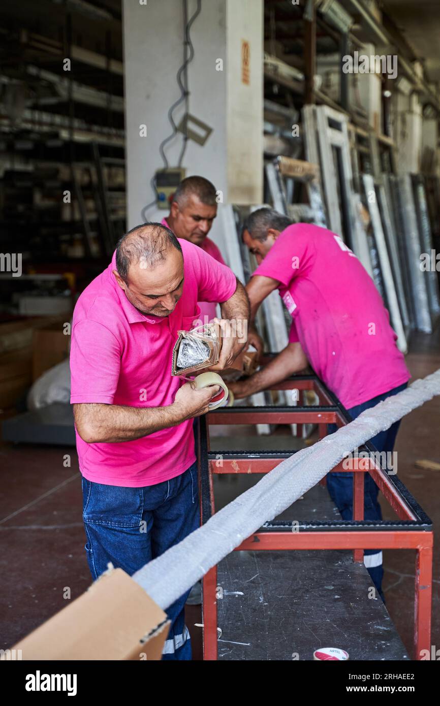 Workers packing cardboard box in warehouse for shipment. an operator ...