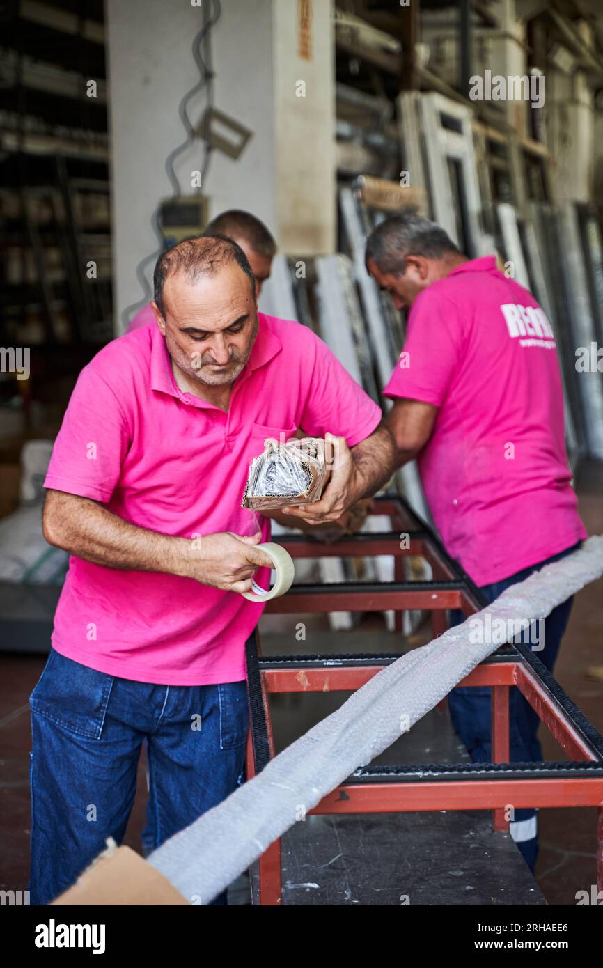 Workers packing cardboard box in warehouse for shipment. an operator ...