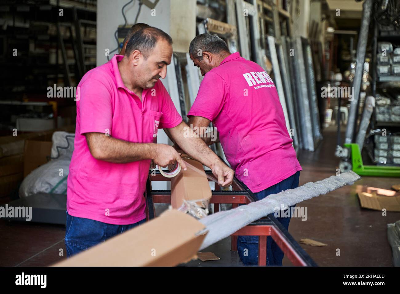 Workers packing cardboard box in warehouse for shipment. an operator ...
